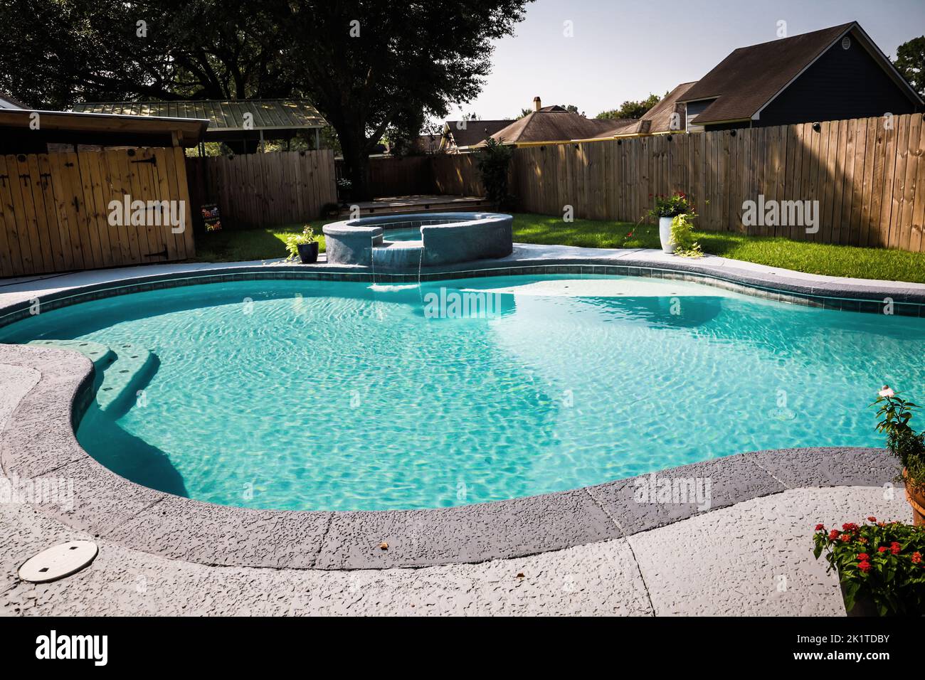 A large free form gray grey accent swimming pool with turquoise blue ...