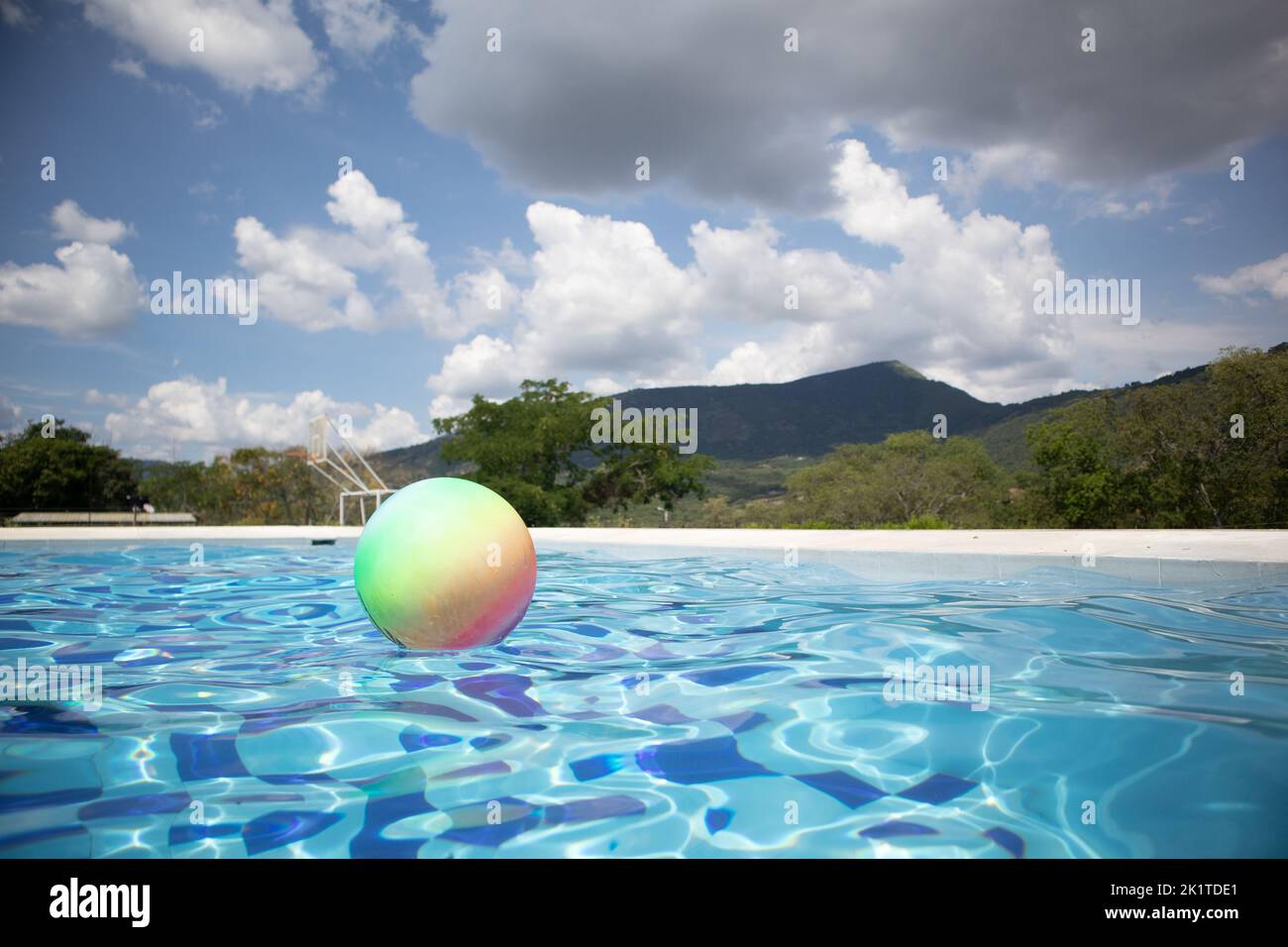 A closeup shot of a colorful pool ball on the water on a sunny day ...