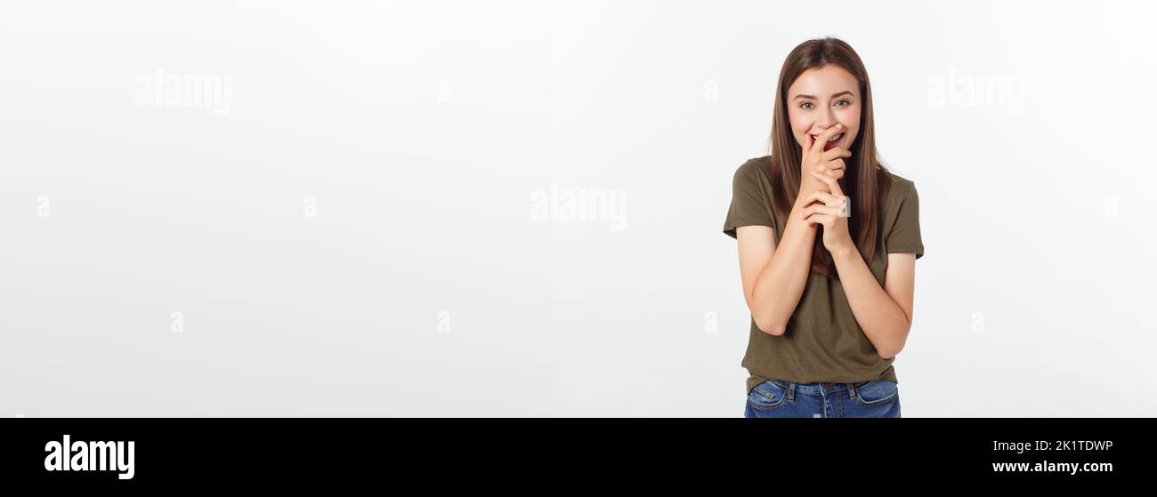 Happy woman laughing covering her mouth with a hands isolate over grey ...