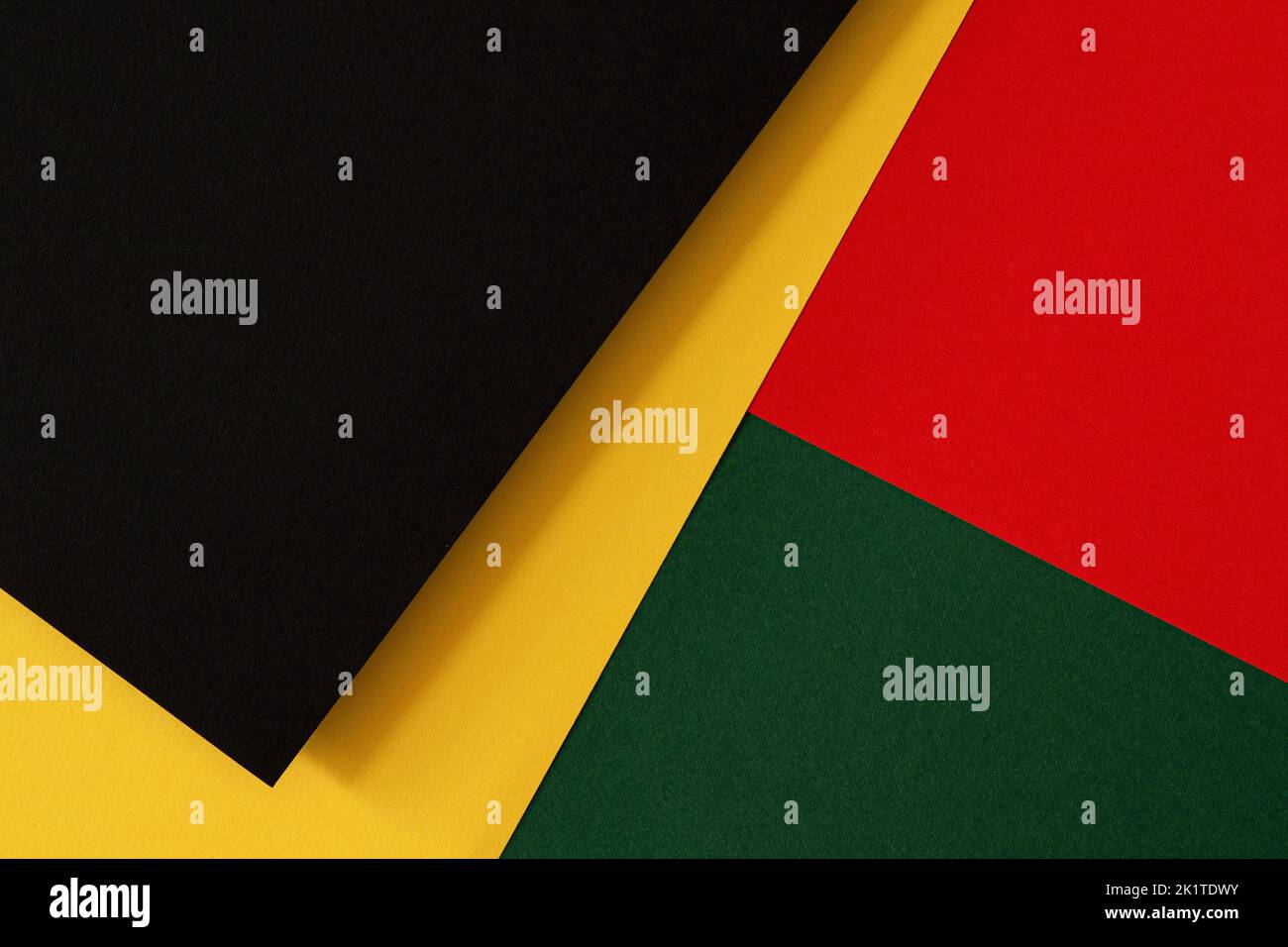 Abstract geometric black, red, yellow, green color paper background ...