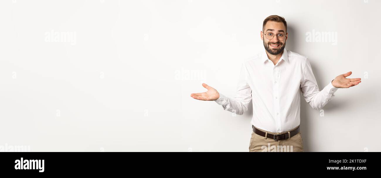 Confused smiling businessman dont know, shrugging and saying sorry ...