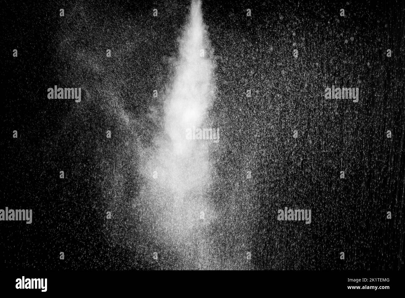 Stream of white curly steam with water drops on a black background ...