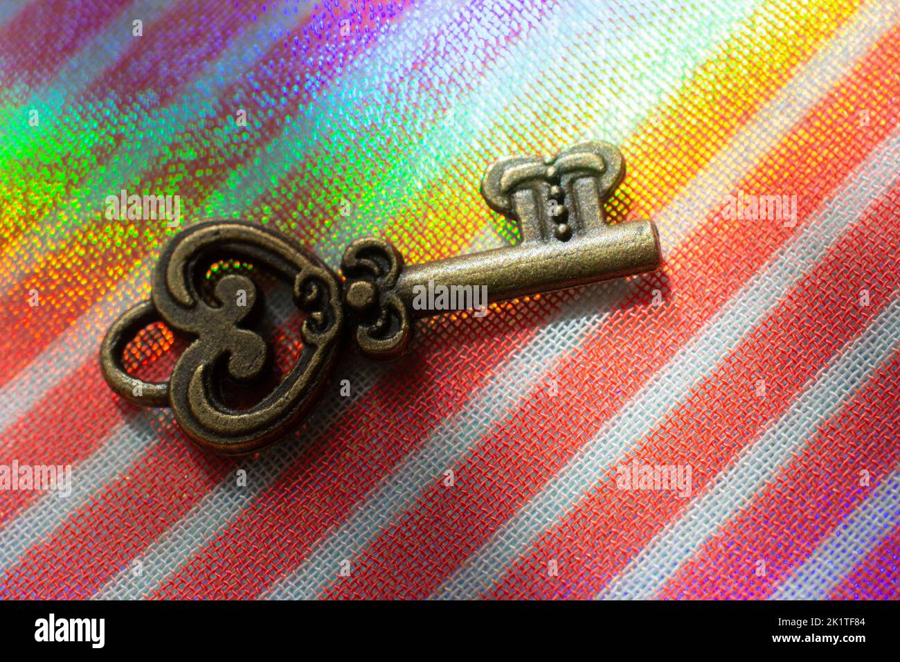 Vintage key. .Antique key. Retro key on colorful fabric background ...
