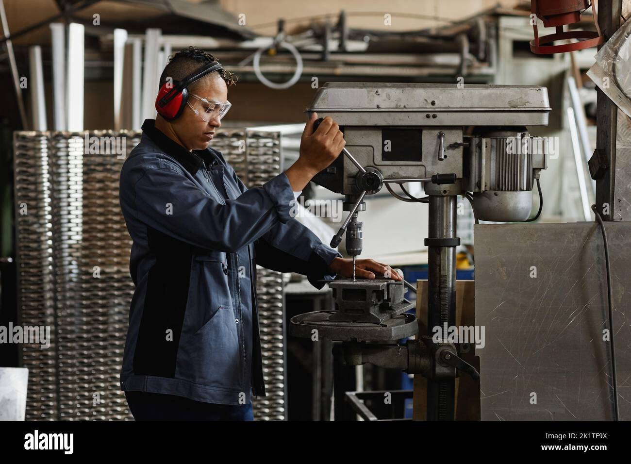 Side view portrait of female worker operating machine units in ...