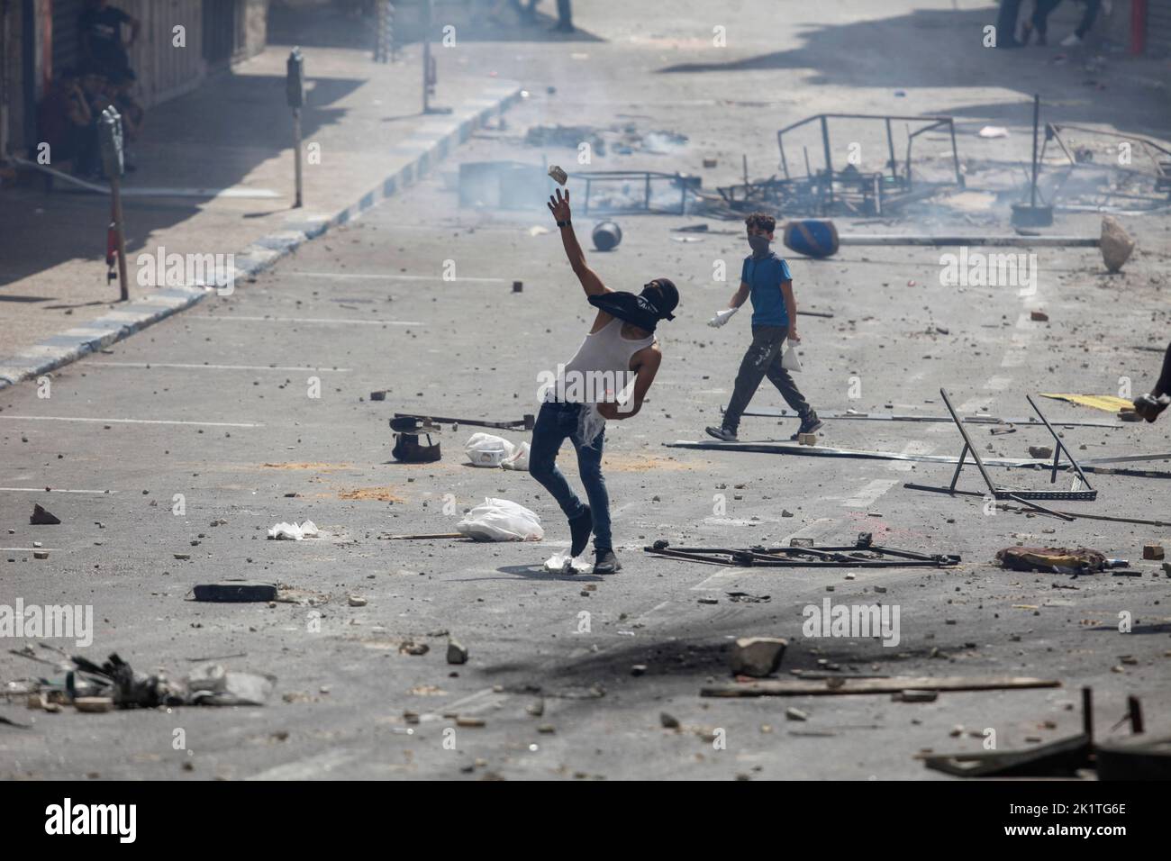 Protesters hurl stones at military vehicles of the Palestinian security ...