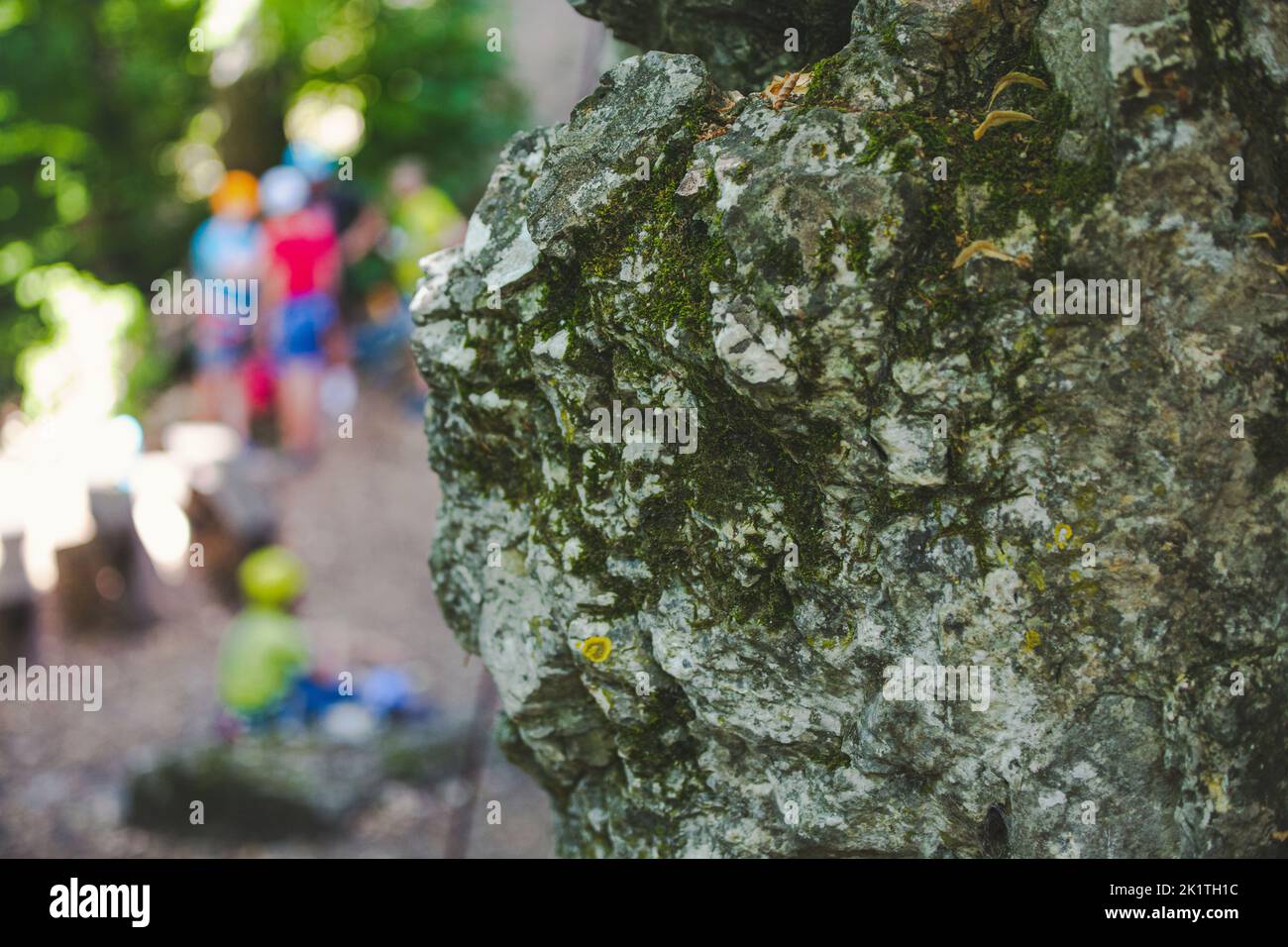 A rock cliff with climbers on the bottom Stock Photo - Alamy