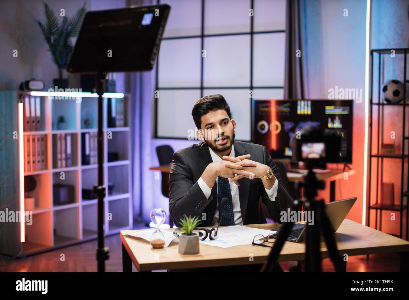 Confident indian bearded businessman, broker in suit sitting in front ...