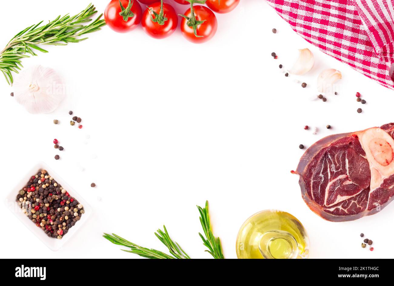 ingredients for cooking. raw beef steak with bone and spices, tomatoes ...