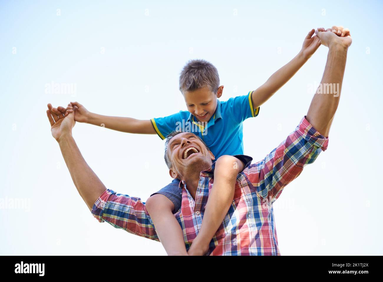 Dads pride and joy. A low angle shot of a happy father carrying his ...
