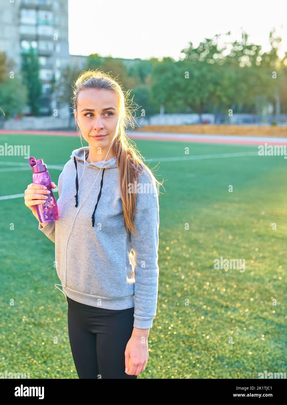Sports girl doing stretching on the stadium lawn Stock Photo - Alamy