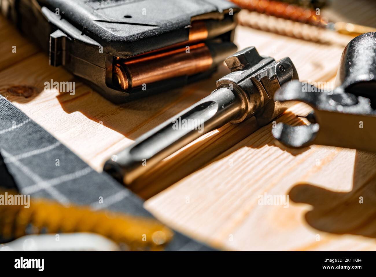 Black disassembled shotgun and cleaning tools on wooden table Stock ...