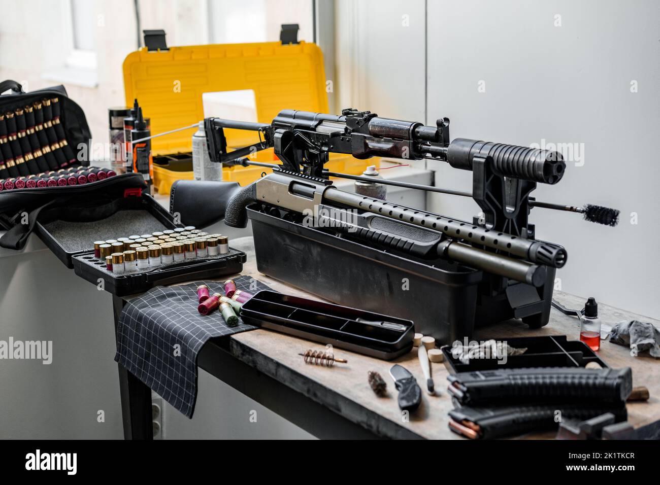 Shotgun rifle with cartridges on table in a weapon workshop Stock Photo ...