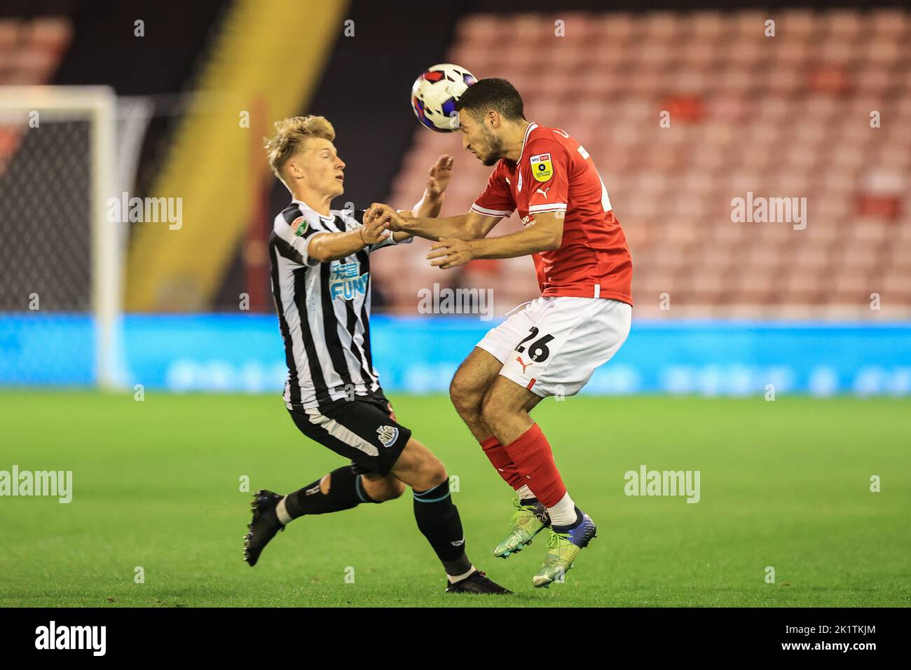 Ziyad Larkeche #26 of Barnsley wins the ball from Nathan Carlyon #43 of ...