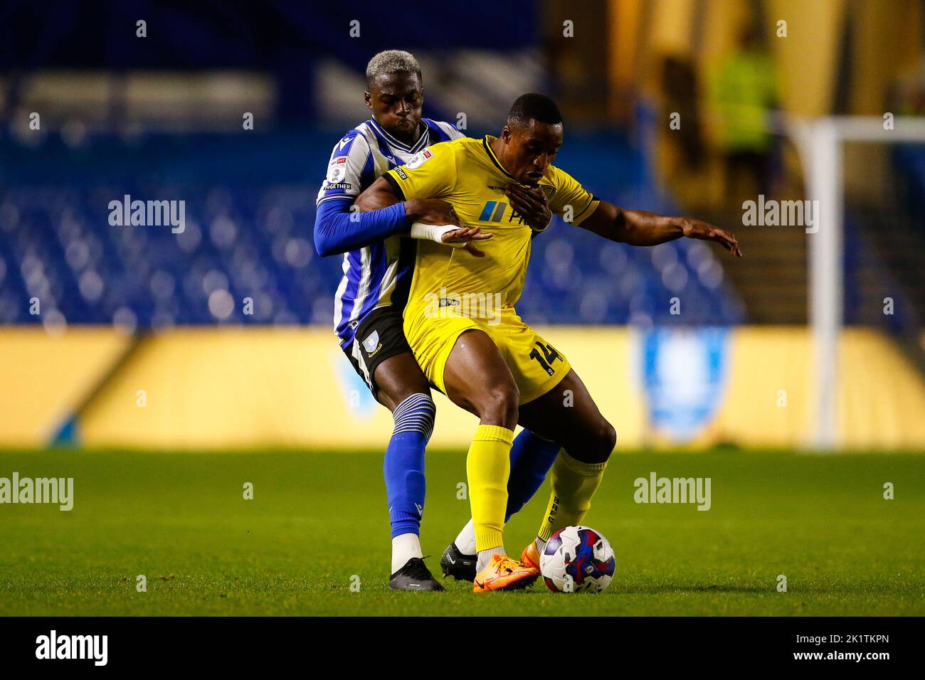 Victor Adeboyejo #14 of Burton Albion and Dominic Iorfa #6 of Sheffield ...