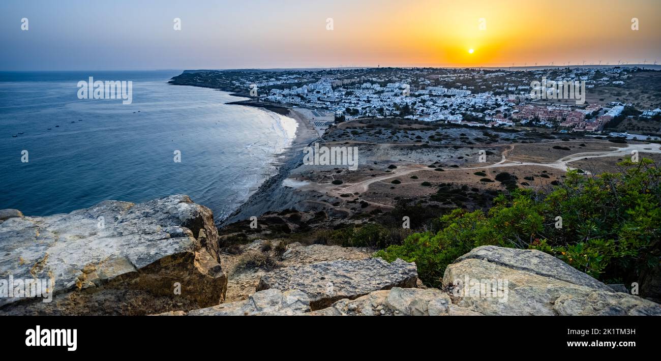 A beautiful sunset over the town and the beach Stock Photo - Alamy