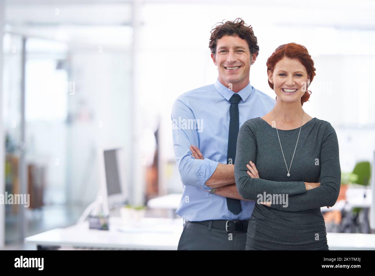 They work well together. two colleagues standing in an office Stock ...