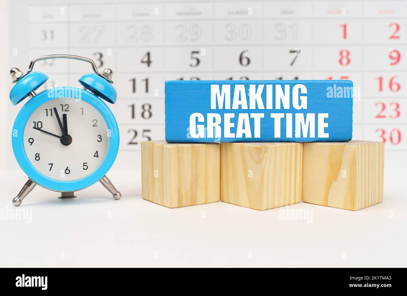 Time concept. Against the background of the calendar is an alarm clock ...