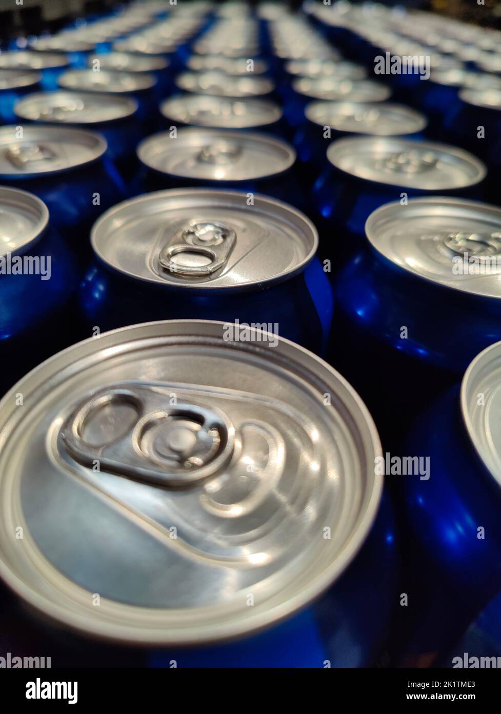 A blue soda can lined at the factory Stock Photo - Alamy
