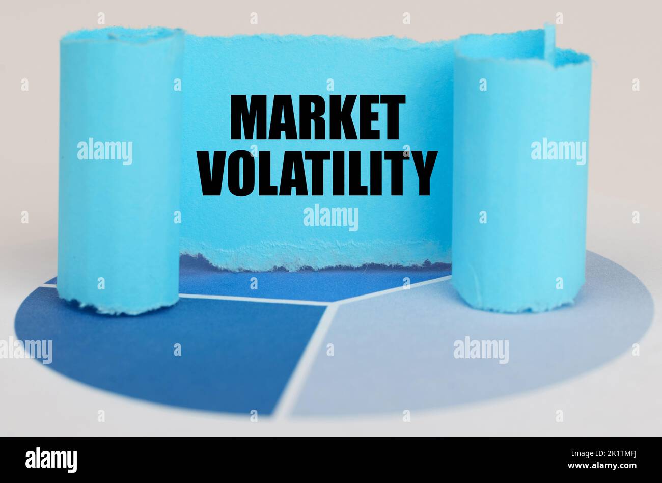 Business concept. On the blue diagram is a twisted paper sign with the ...