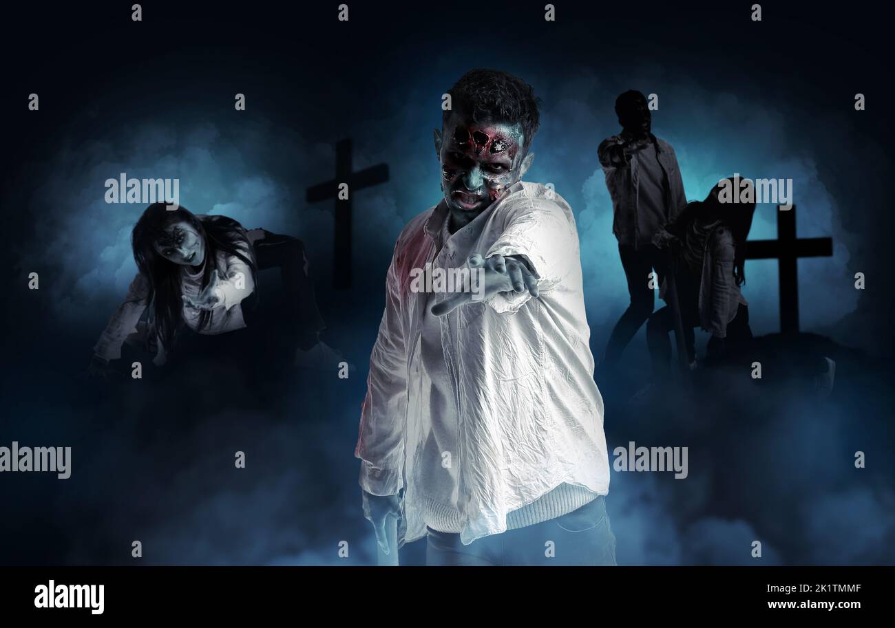 Scary zombies at night cemetery Stock Photo - Alamy