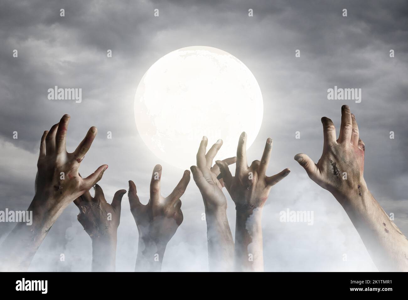 Hands of zombies and full moon in night sky Stock Photo - Alamy