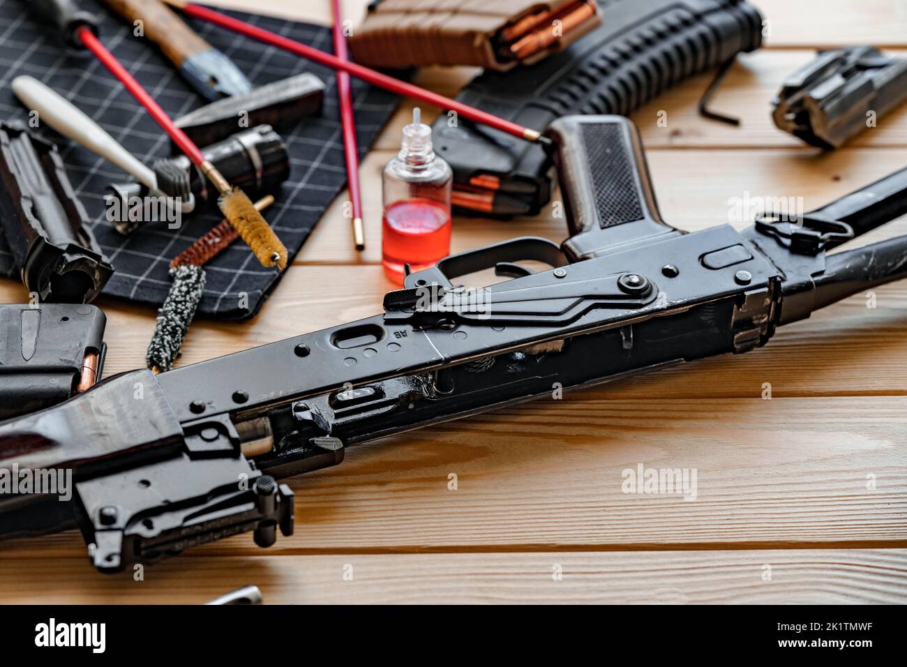 Black disassembled shotgun and cleaning tools on wooden table Stock ...