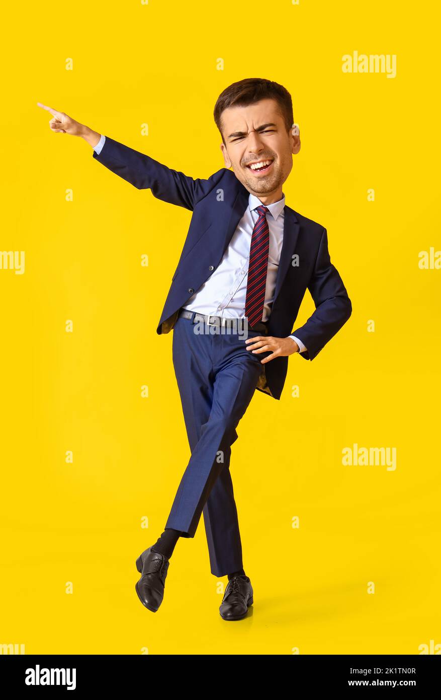 Happy dancing businessman with big head on yellow background Stock ...