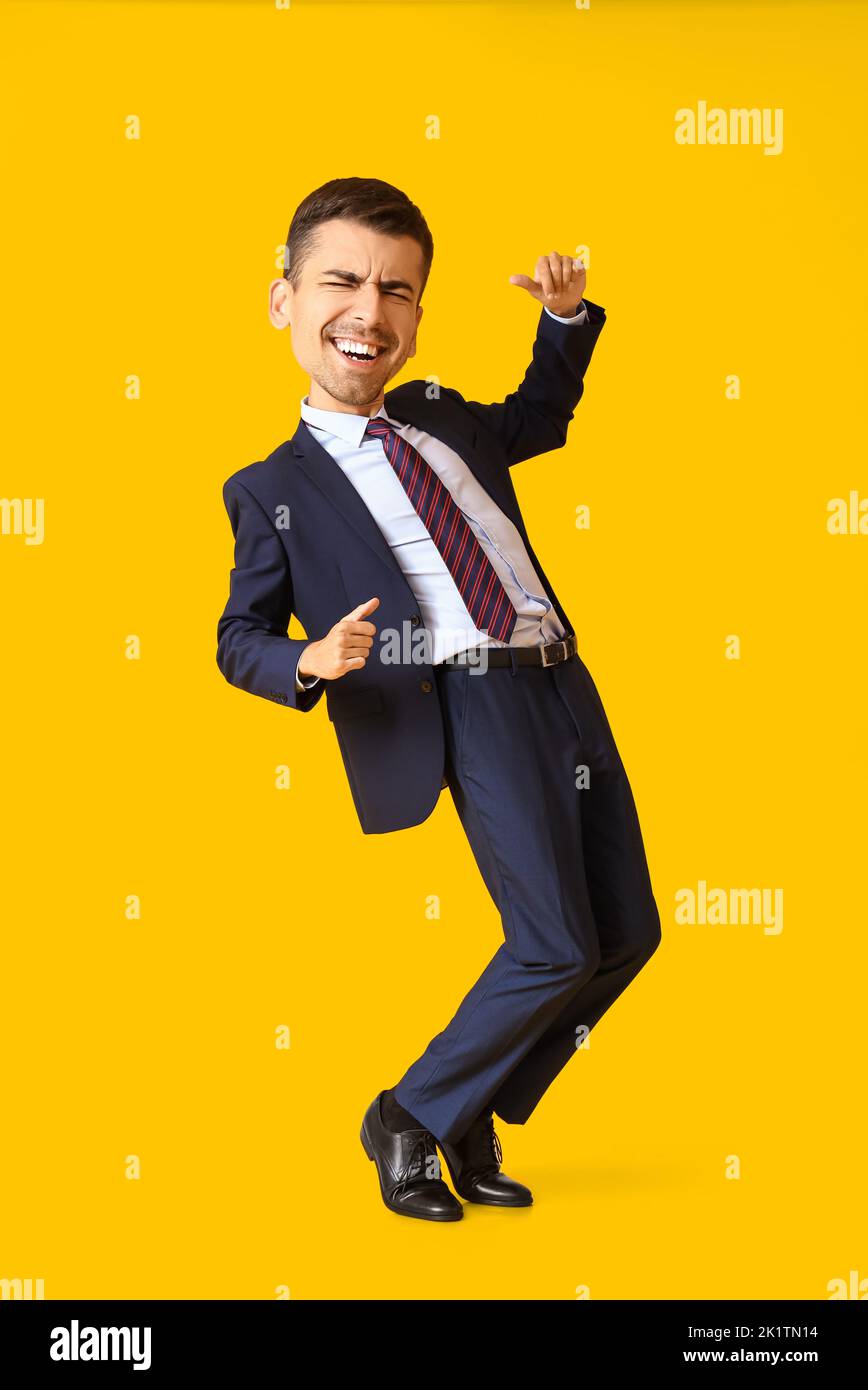 Funny dancing businessman with big head on yellow background Stock ...