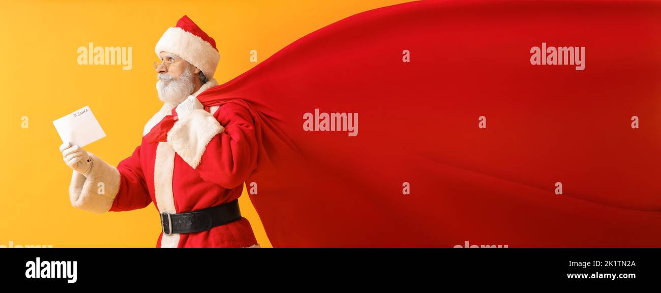 Santa Claus with letter and bag on yellow background. Banner for design ...