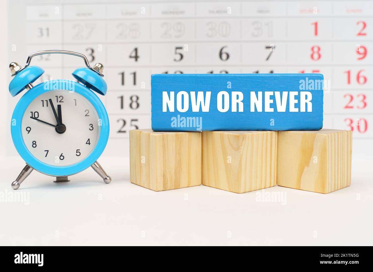 Time concept. Against the background of the calendar is an alarm clock ...