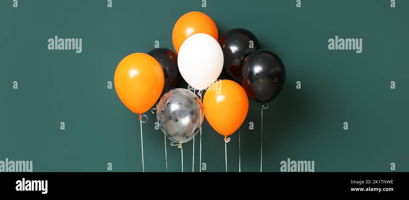 Halloween balloons on green background Stock Photo - Alamy