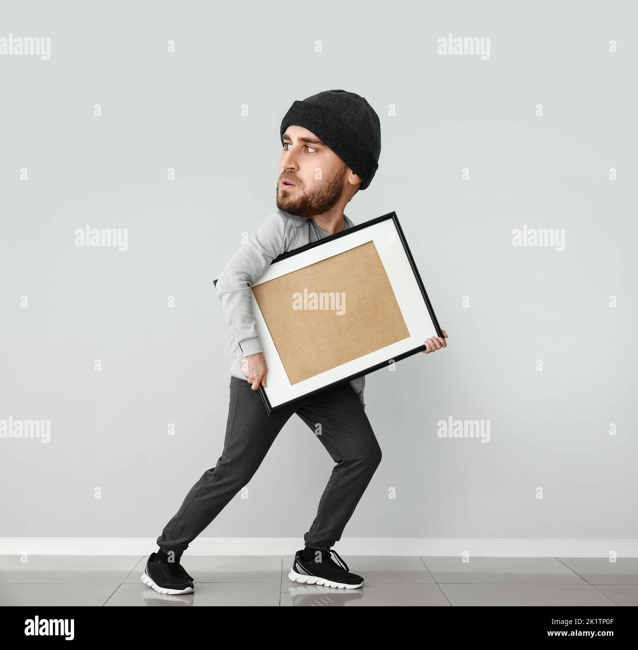 Funny thief with big head stealing picture from art gallery Stock Photo ...