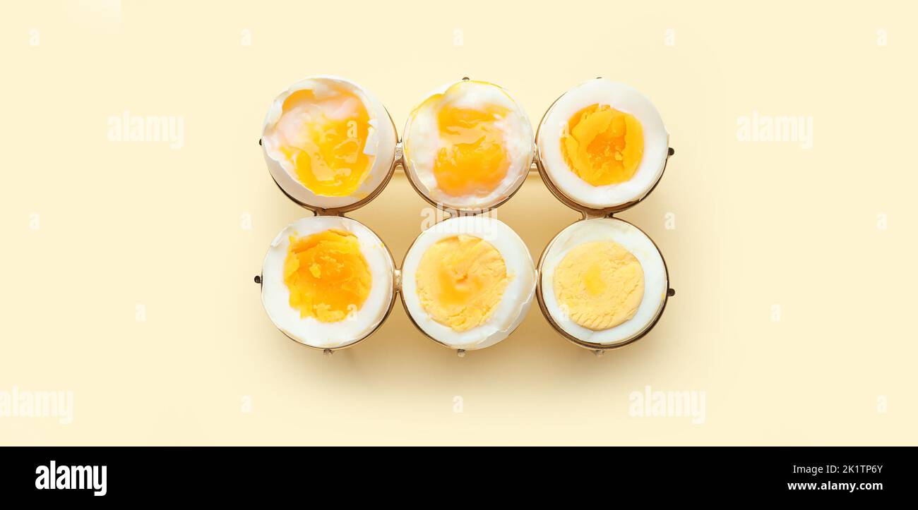 Different stages of boiling eggs on beige background, top view Stock ...