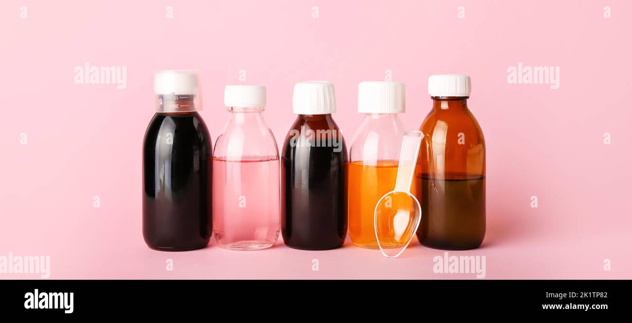 Bottles of cough syrup on pink background Stock Photo - Alamy