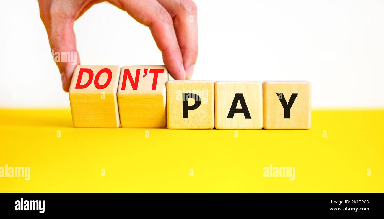 Do not pay symbol. Concept words do not pay on cubes. Businessman hand ...
