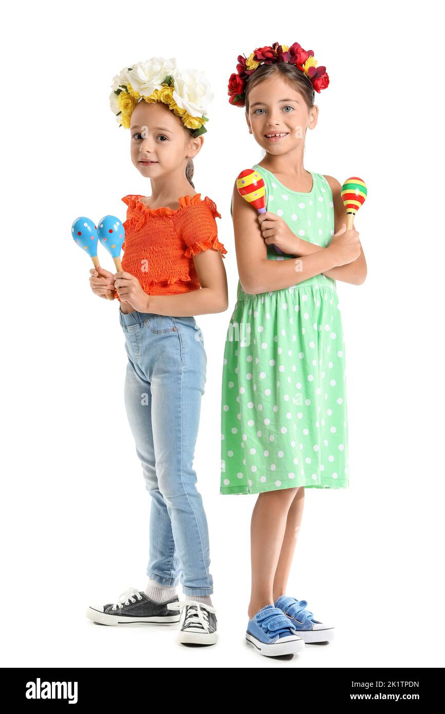 Little Mexican girls with floral wreaths and maracas on white ...