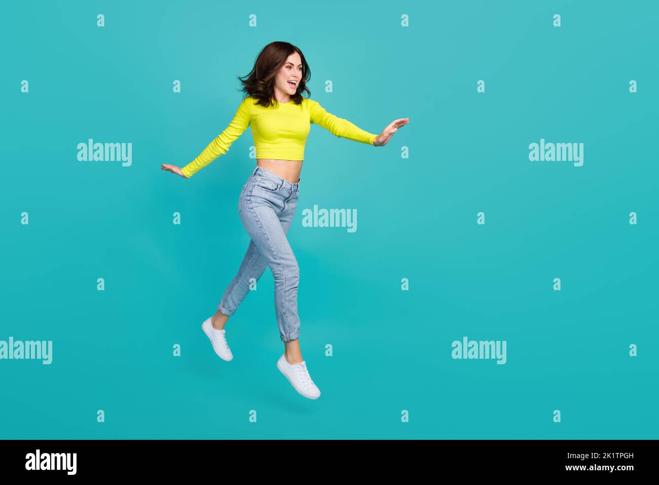 Full body portrait of active cheerful lady rush jump look empty space ...