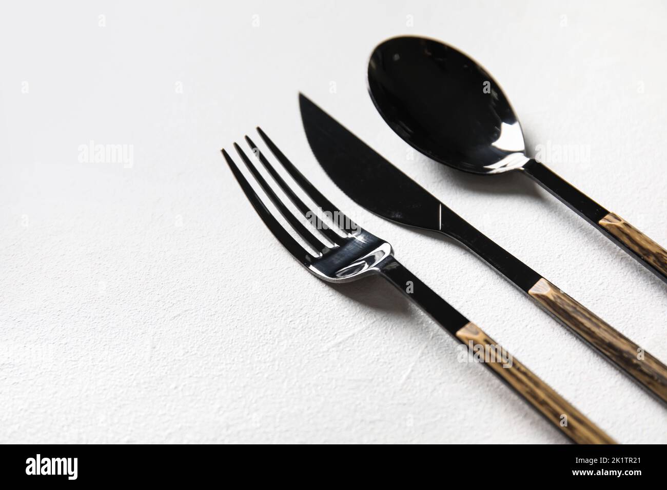 Fork, knife and spoon on white background, closeup Stock Photo - Alamy