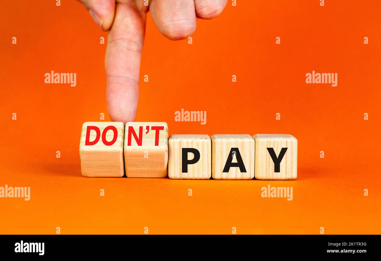 Do not pay symbol. Concept words do not pay on cubes. Businessman hand ...