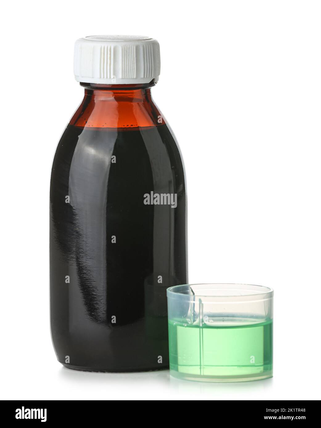 Bottle of cough syrup and cup on white background Stock Photo - Alamy
