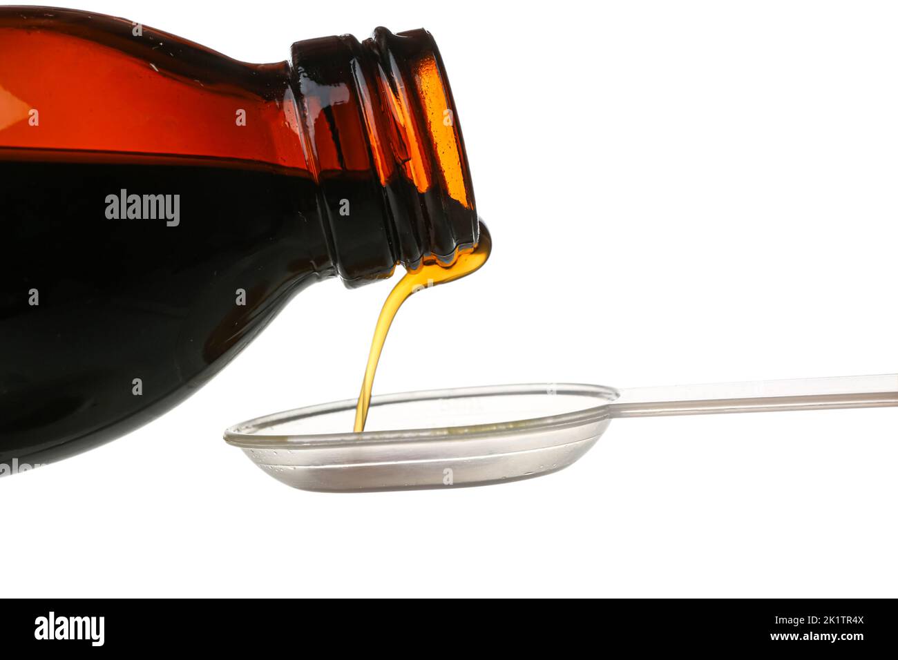 Pouring of cough syrup from bottle into spoon on white background Stock ...
