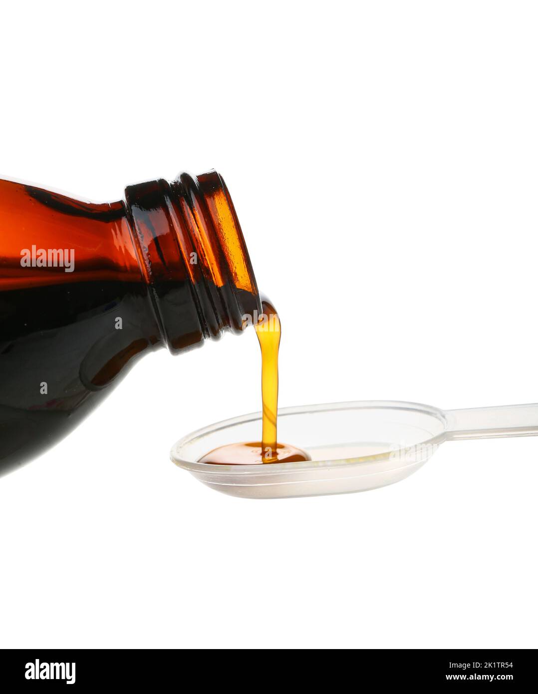 Pouring of cough syrup from bottle into spoon on white background Stock ...