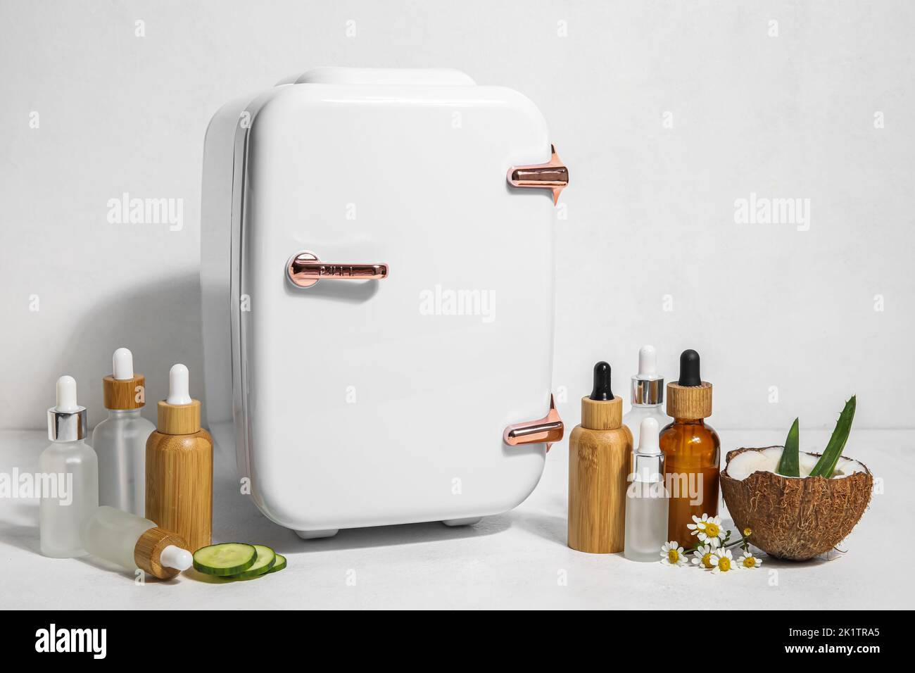 Small refrigerator with natural cosmetics and ingredients on white ... Small refrigerator with natural cosmetics and ingredients on white ...
