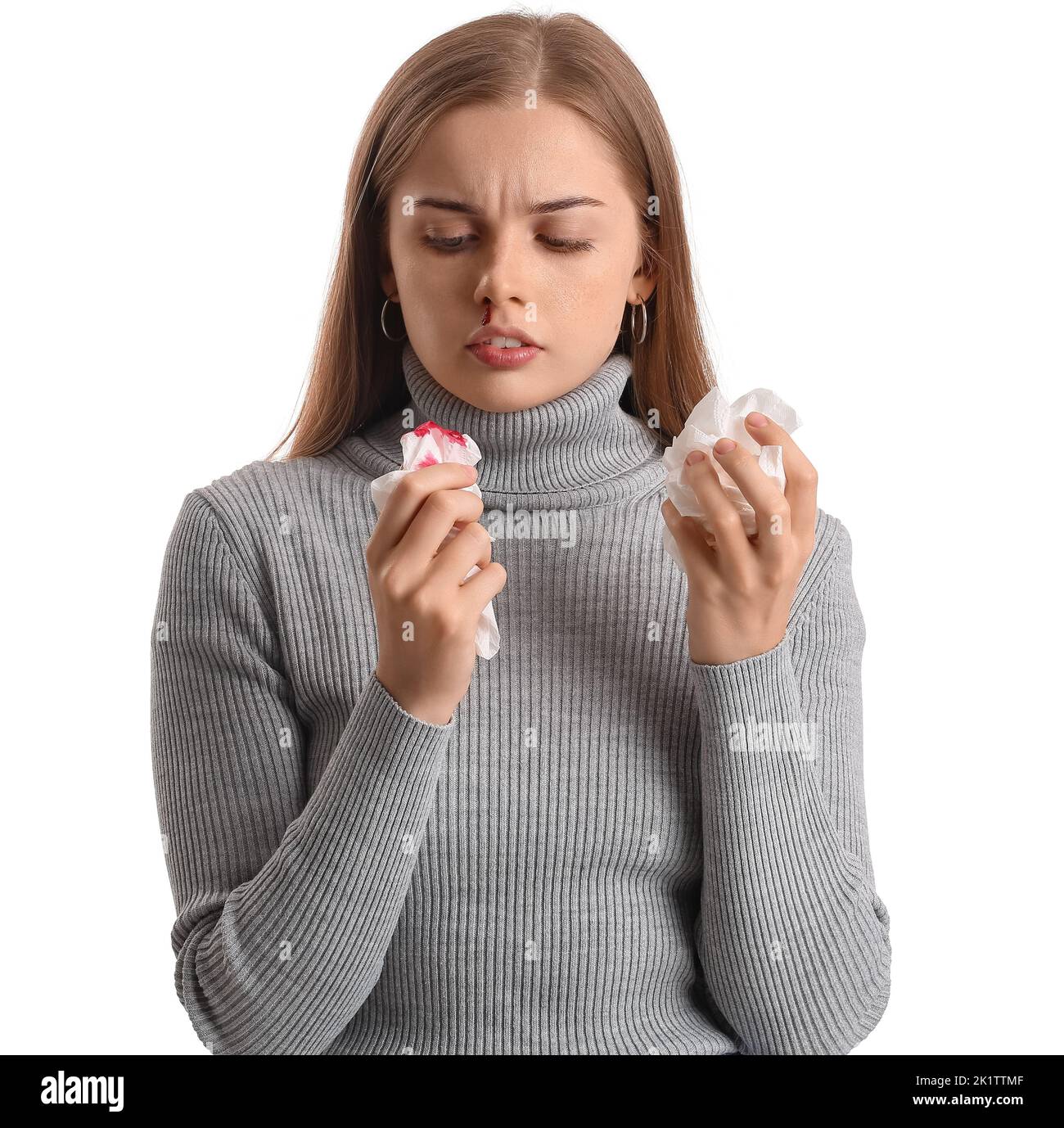 Young woman with nosebleed and tissue on white background Stock Photo ...