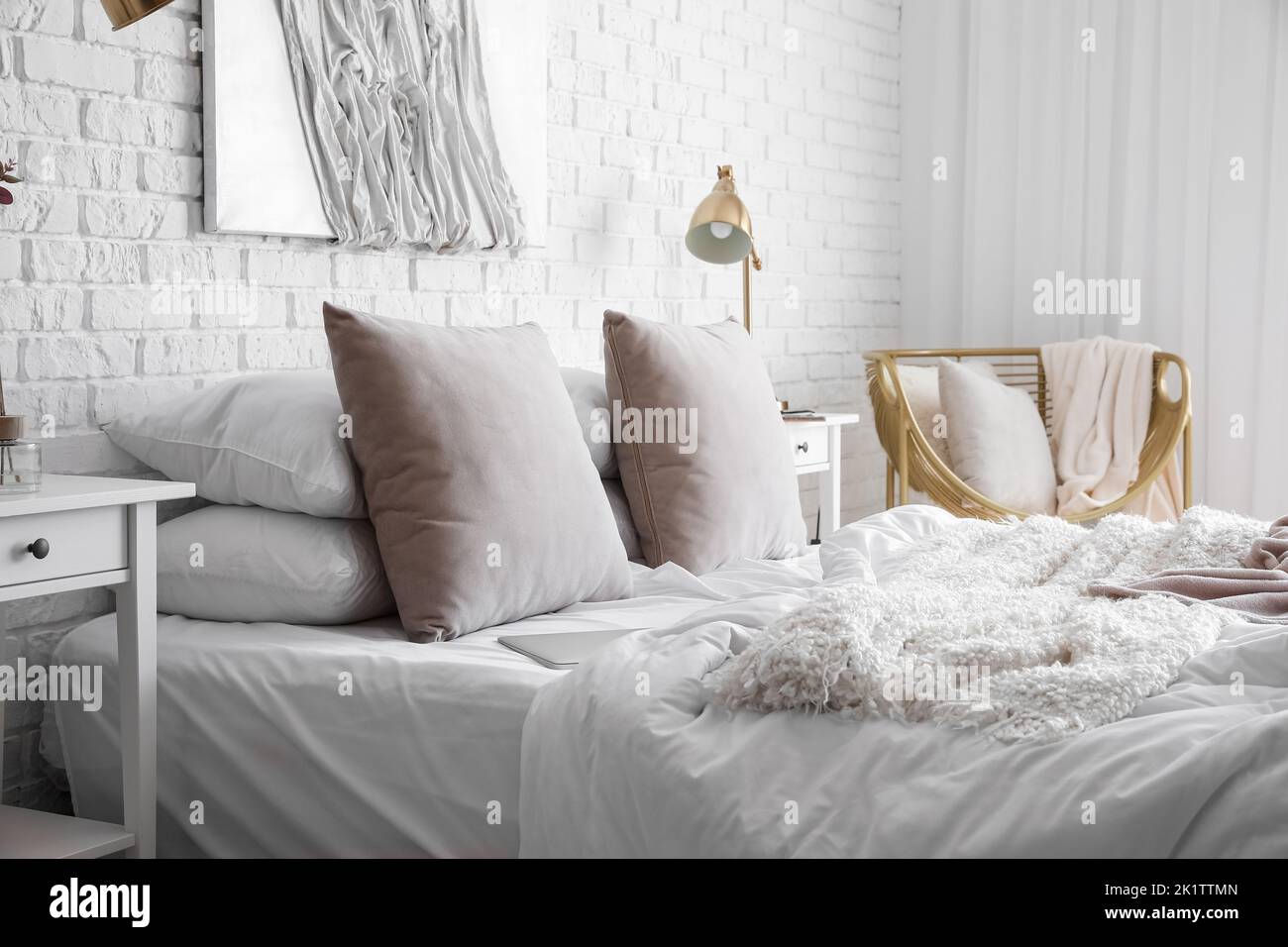 Bed with beautiful linen in light room Stock Photo - Alamy