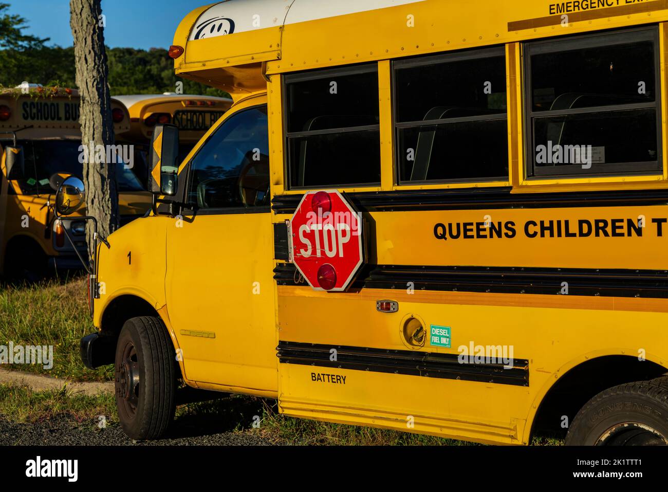 Yellow school bus against blue sky. Stop sign on a side. School bus ...