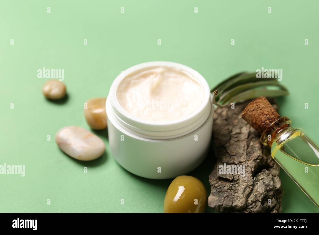 Jar of natural olive cream on green background, closeup Stock Photo - Alamy