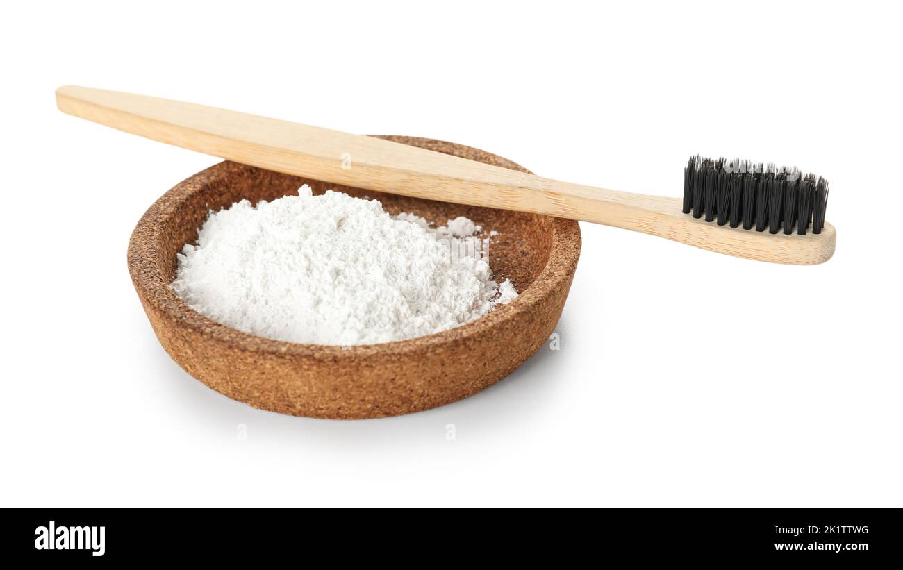 Bowl of tooth powder and brush on white background Stock Photo - Alamy