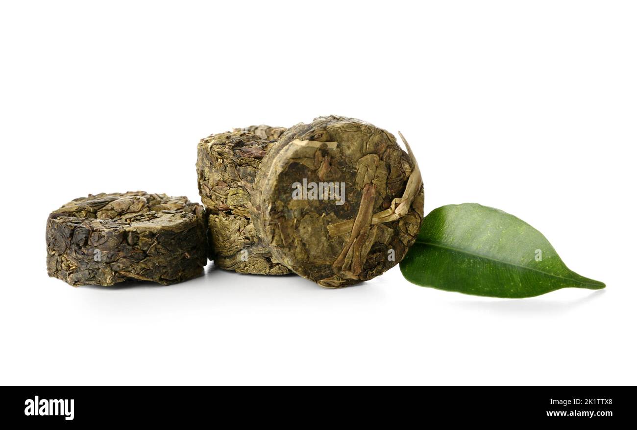 Dry pressed puer tea with leaf on white background Stock Photo - Alamy