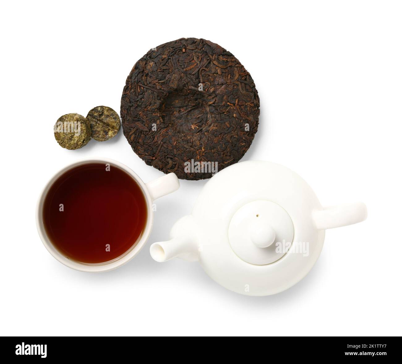Dry pressed puer tea with cup and teapot on white background Stock ...